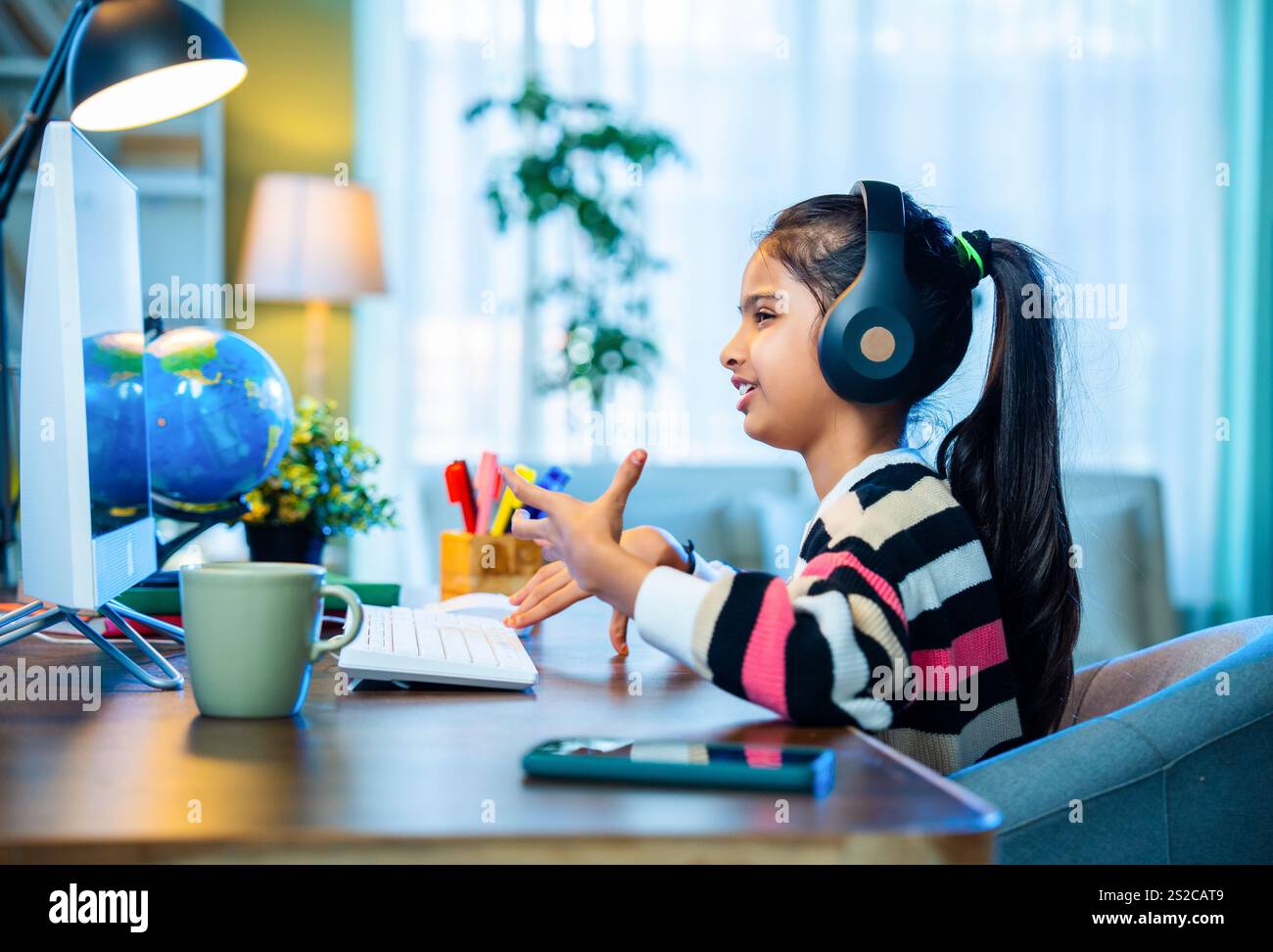 Studious Indian Asian Elementary Grade Girl Attending Virtual Online ...