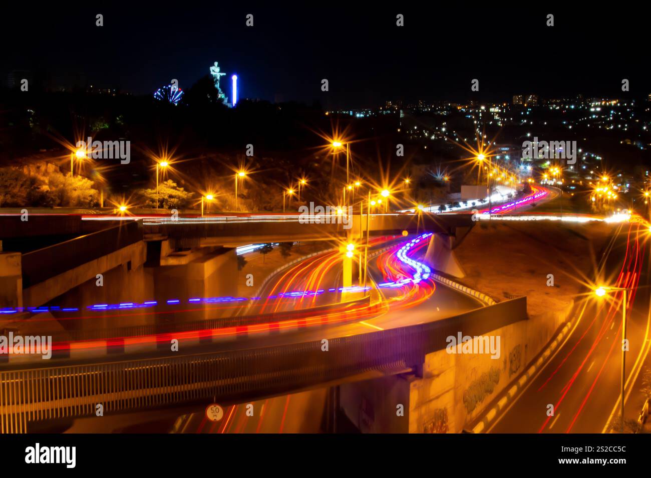 Car traffic on highways in the city at night. The movement of cars on ...