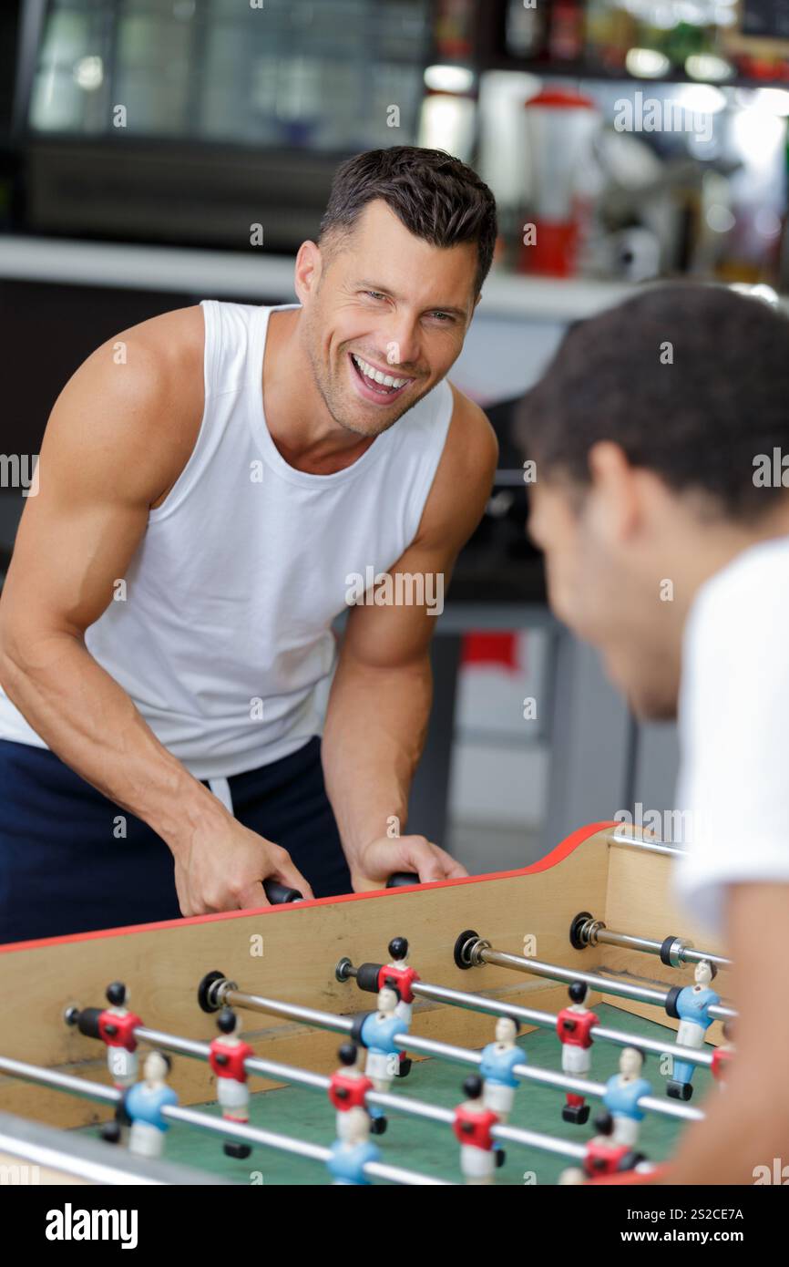 man playing football table game Stock Photo - Alamy