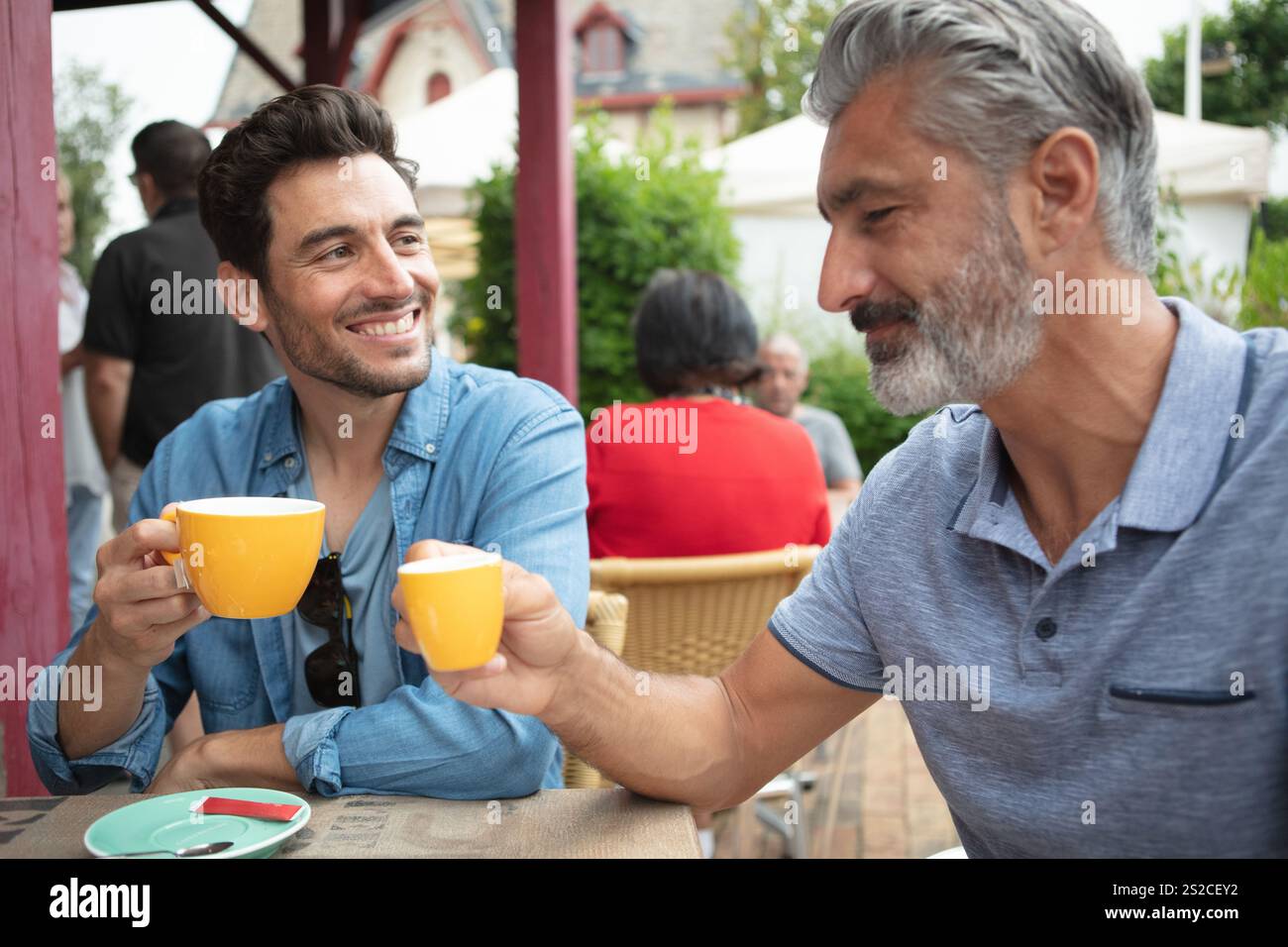 two men cheers drink coffee Stock Photo - Alamy