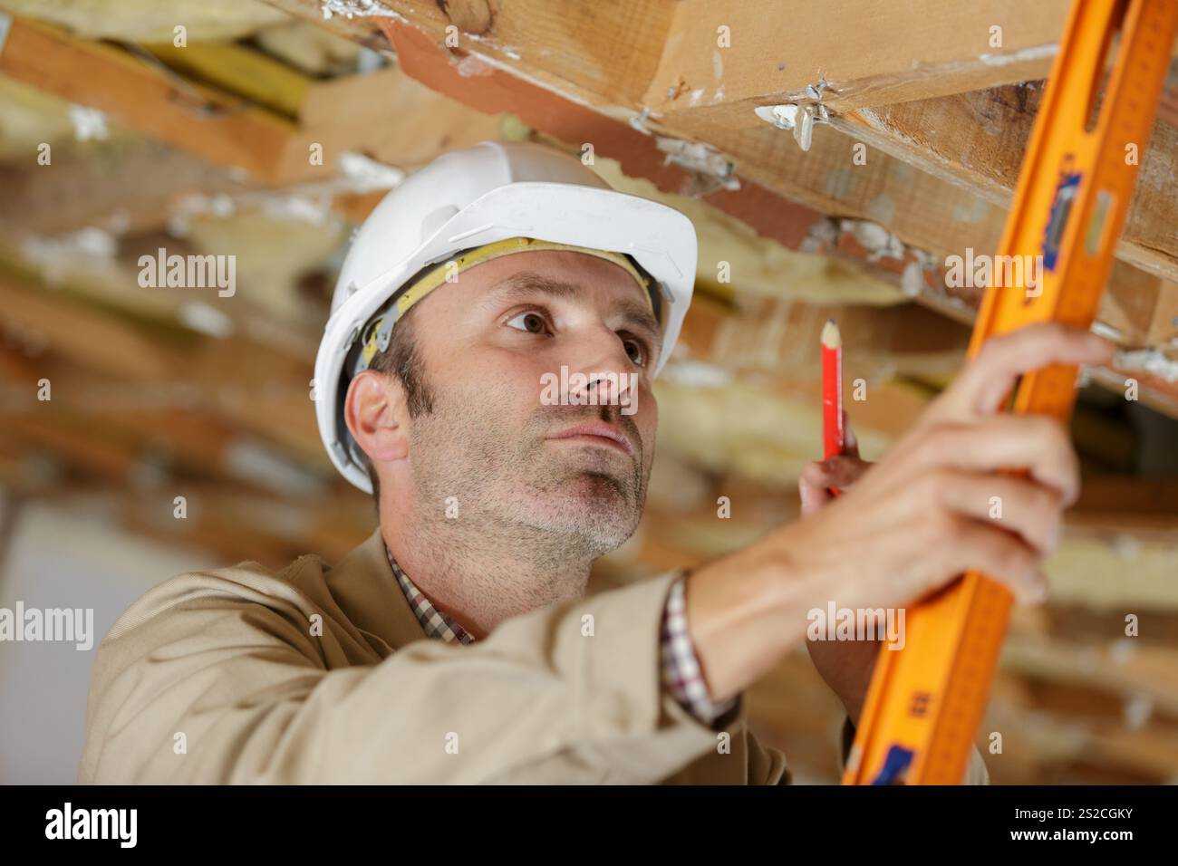 Skilled construction worker using spirit hi-res stock photography and ...