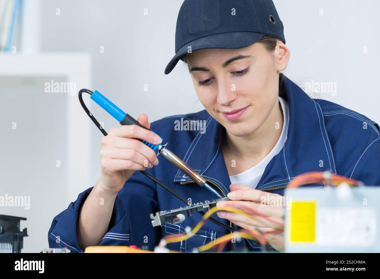 woman soldering and melting wires with soldering iron Stock Photo - Alamy
