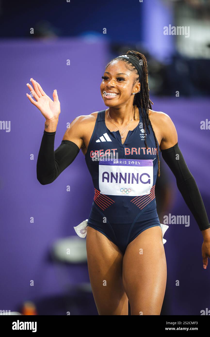 Amber Anning celebrating with her country's flag in the 4x400 meters ...