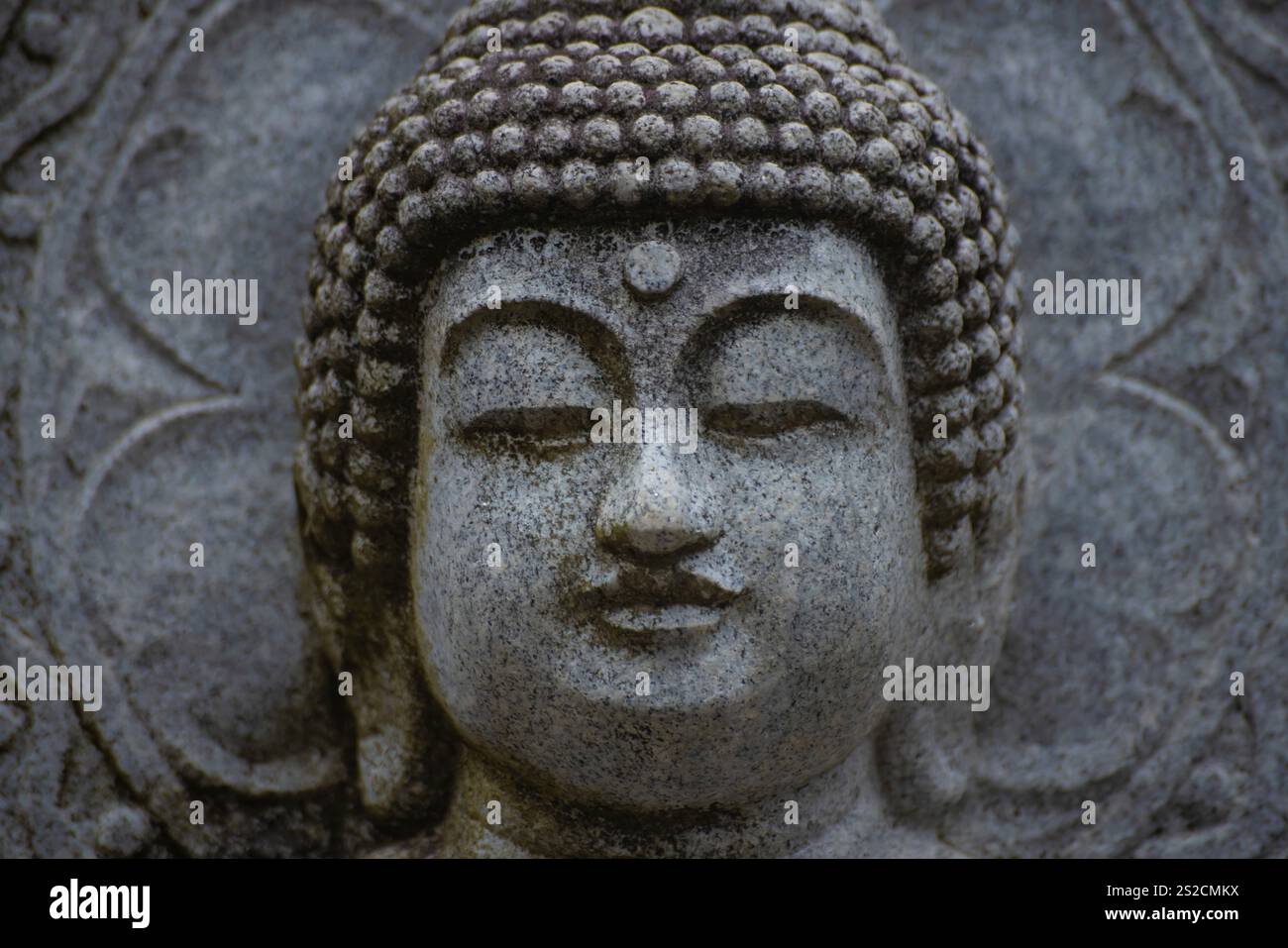A religious stone statue of Shaka Nyorai at Japanese buddhism temple ...