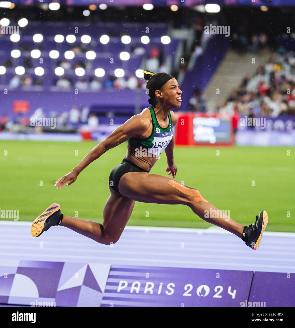 Thea LaFond participating in the triple jump at the Paris 2024 Olympic ...