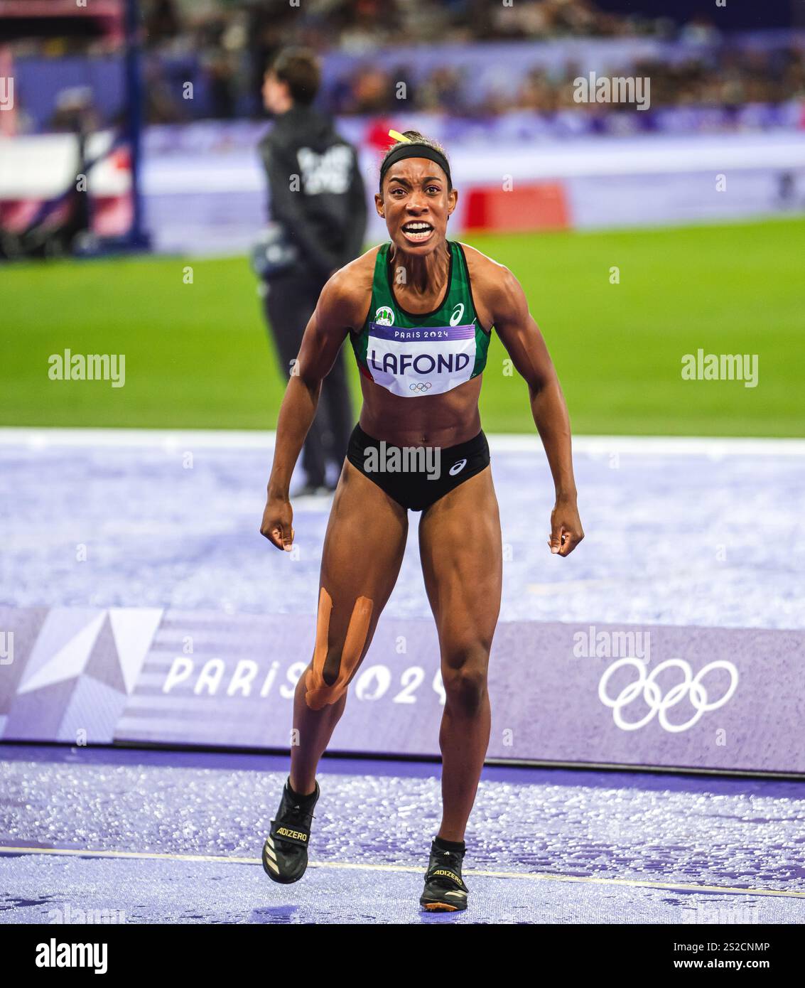 Thea LaFond celebrating her medal with her country's flag at the Paris ...