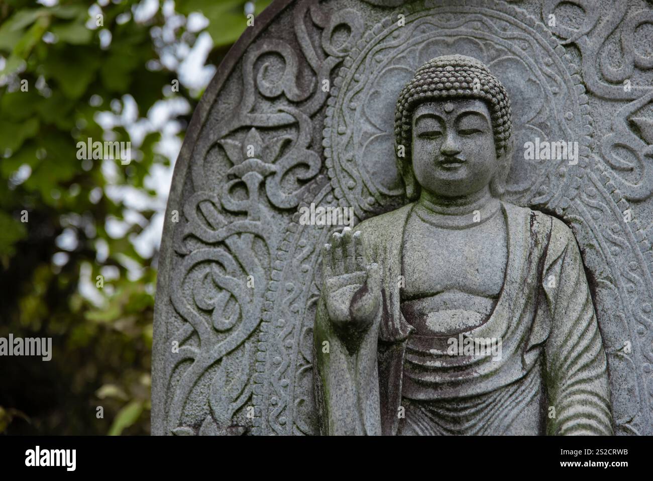 A religious stone statue of Shaka Nyorai at Japanese buddhism temple ...