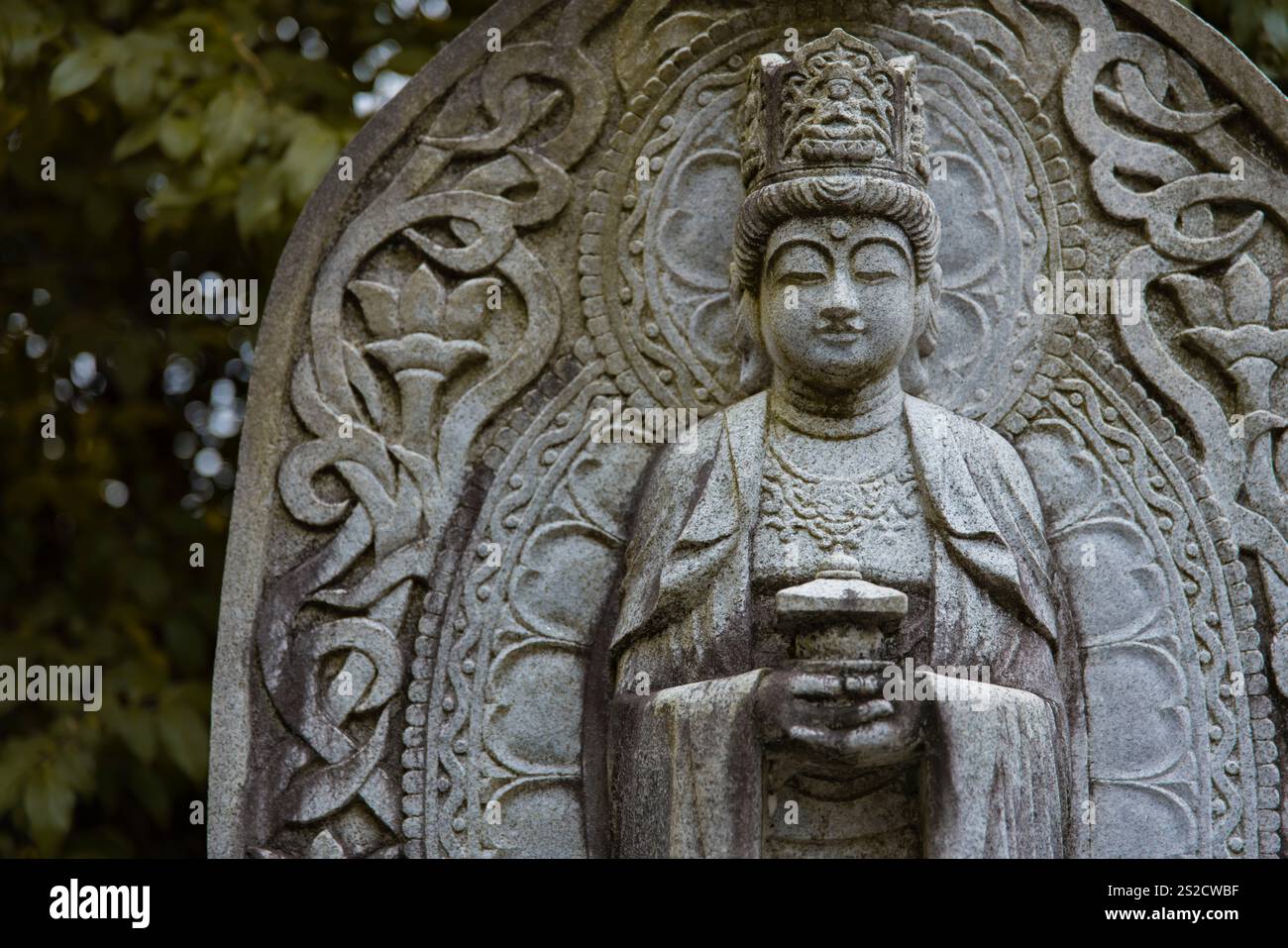 A religious stone statue of Maitreya at Japanese buddhism temple Stock ...