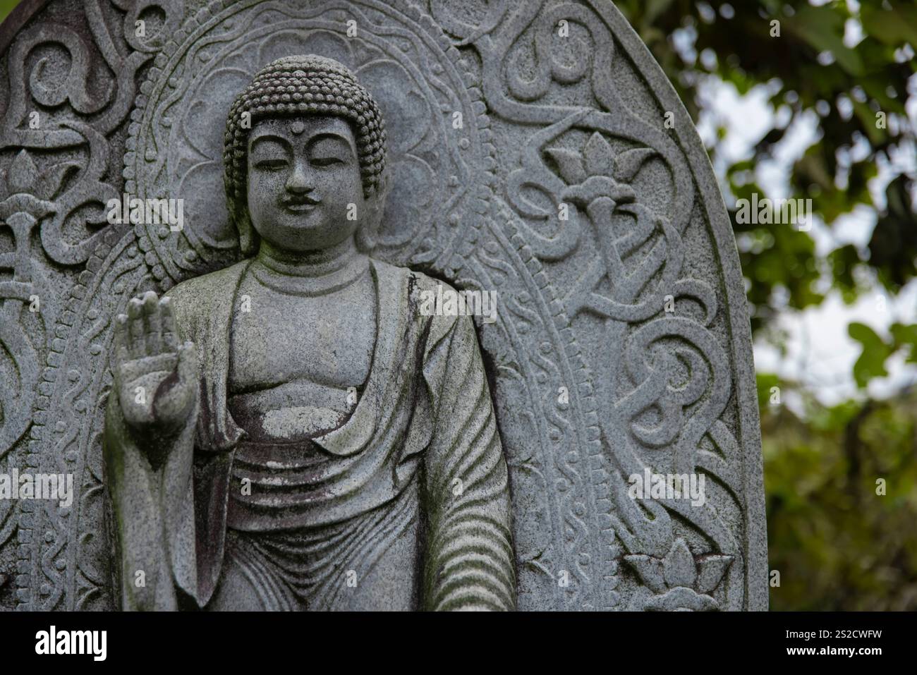 A religious stone statue of Shaka Nyorai at Japanese buddhism temple ...