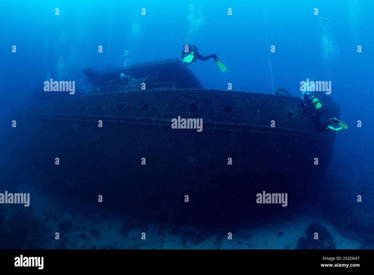 two divers diving near of the wreck of old ship Stock Photo - Alamy