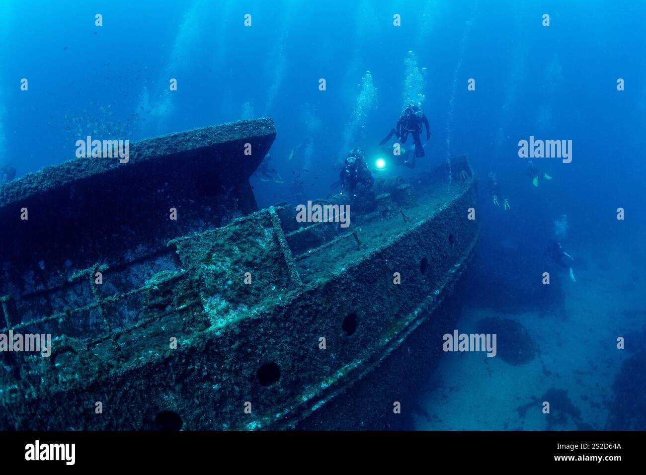 divers group diving near of the wreck of old ship Stock Photo - Alamy