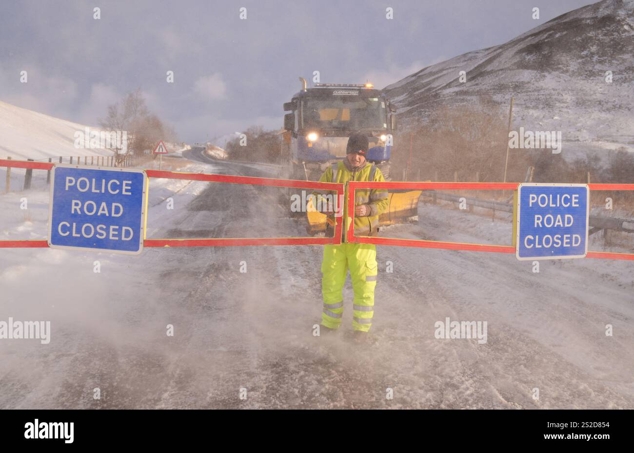 A snow plough driver at the closed snow gates on the A93 in Spittal of ...