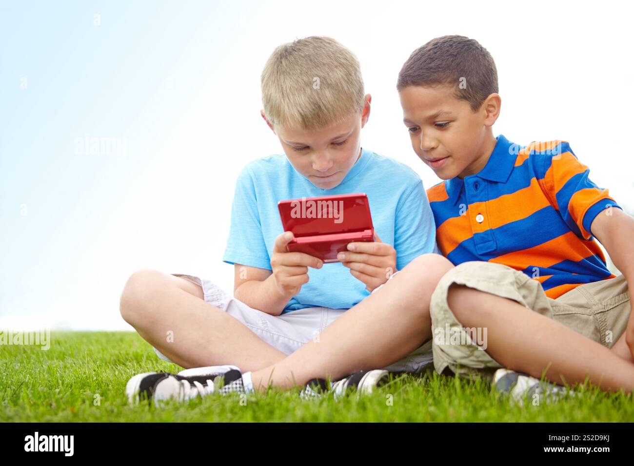 Park, kids and boys with gaming console for playing together, video ...