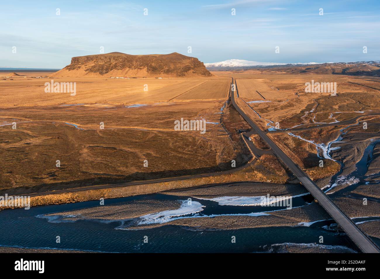 Aerial view of a straight road over a Frozen river, South Iceland ...