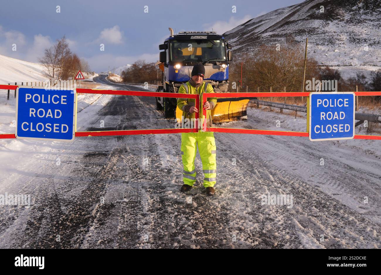 A snow plough driver at the closed snow gates on the A93 in Spittal of ...