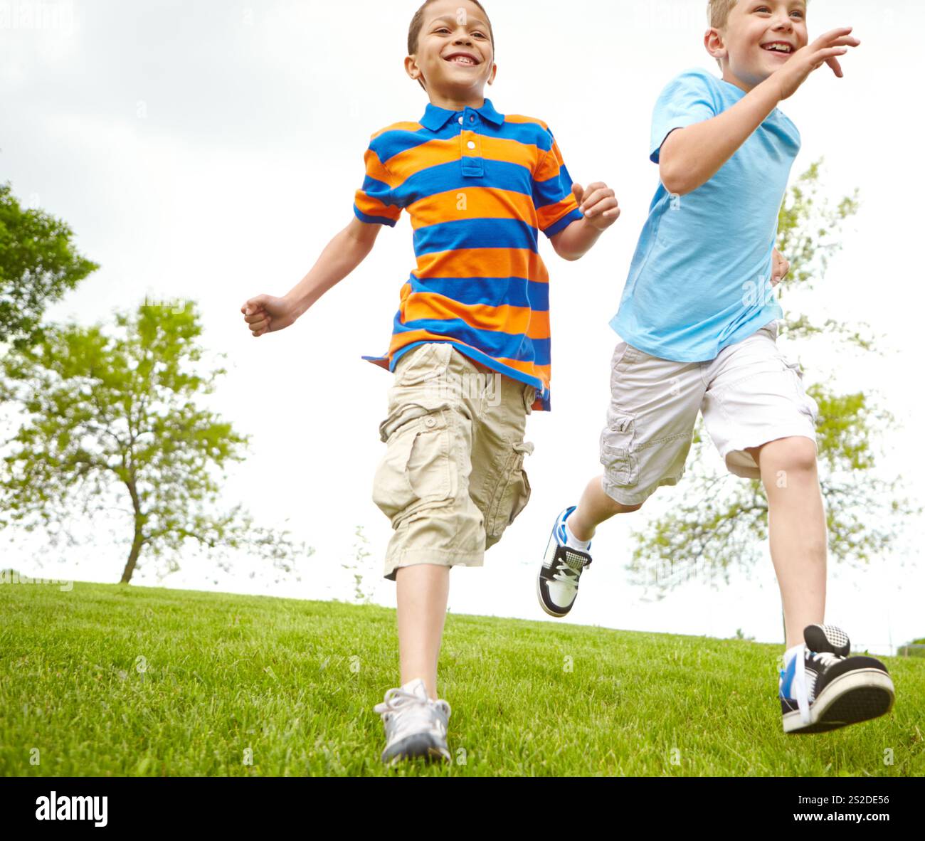 Kids, outdoor and boys with energy, running and excited with nature ...