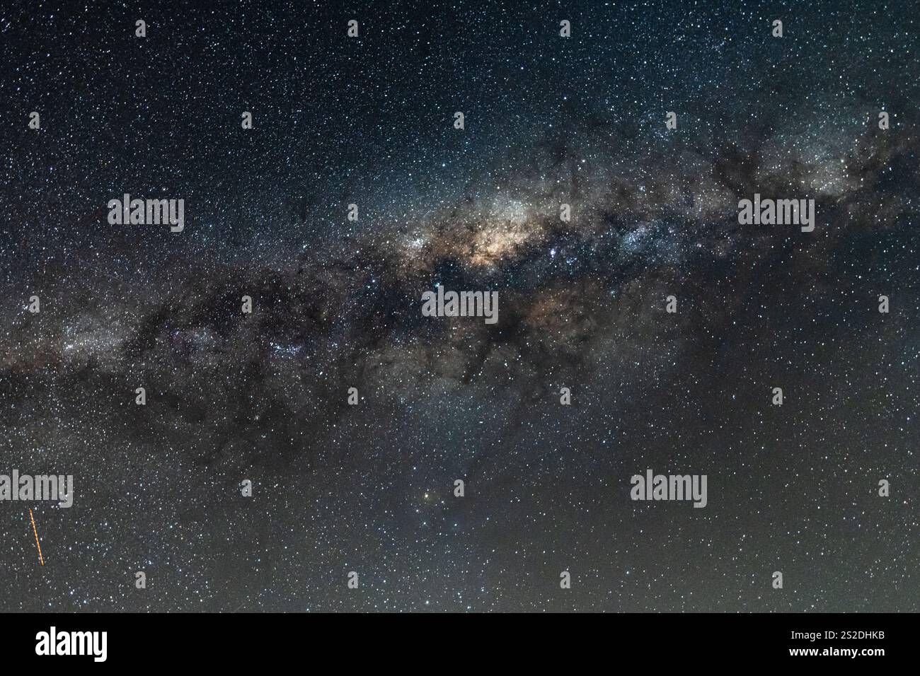 In the darkness of a country night sky the Milky Way shines brightly in ...