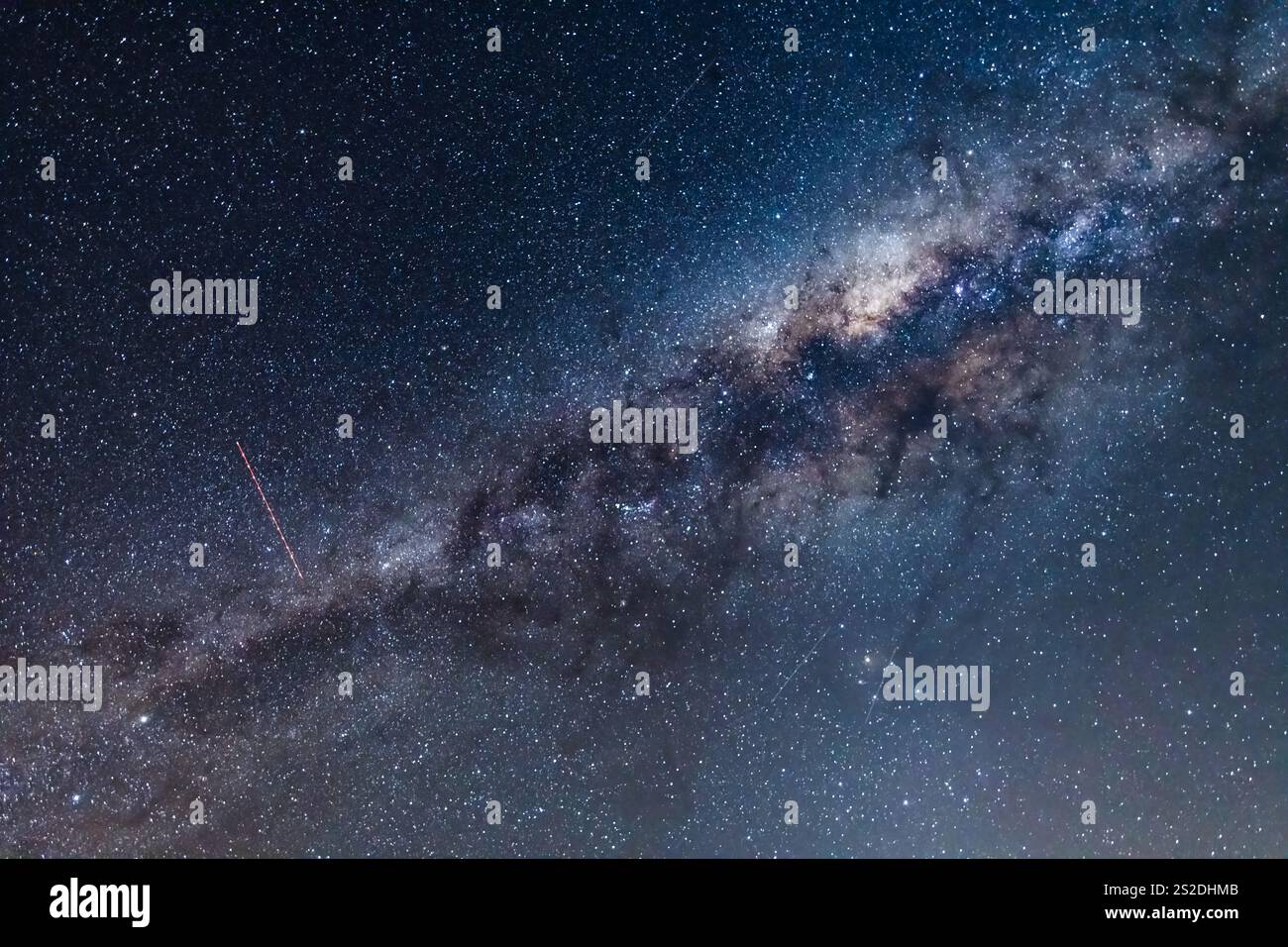 In the darkness of a country night sky the Milky Way shines brightly in ...