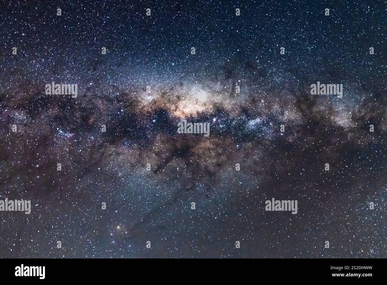 In the darkness of a country night sky the Milky Way shines brightly in ...
