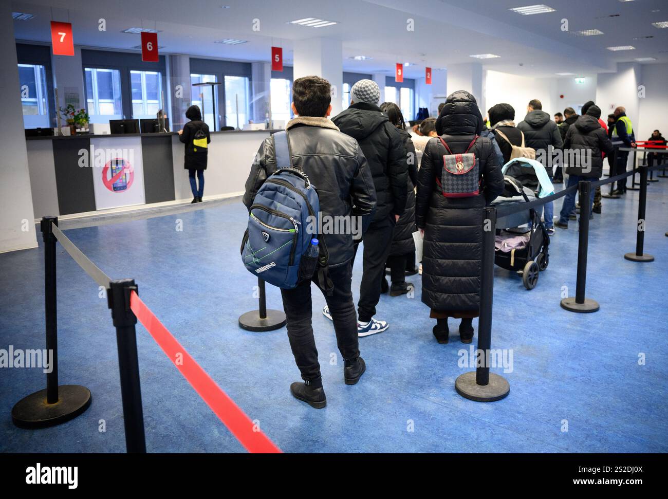 Berlin, Germany. 07th Jan, 2025. Visitors wait in front of information ...