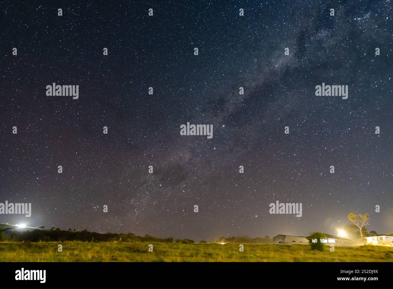 In the darkness of a country night sky the Milky Way shines brightly in ...