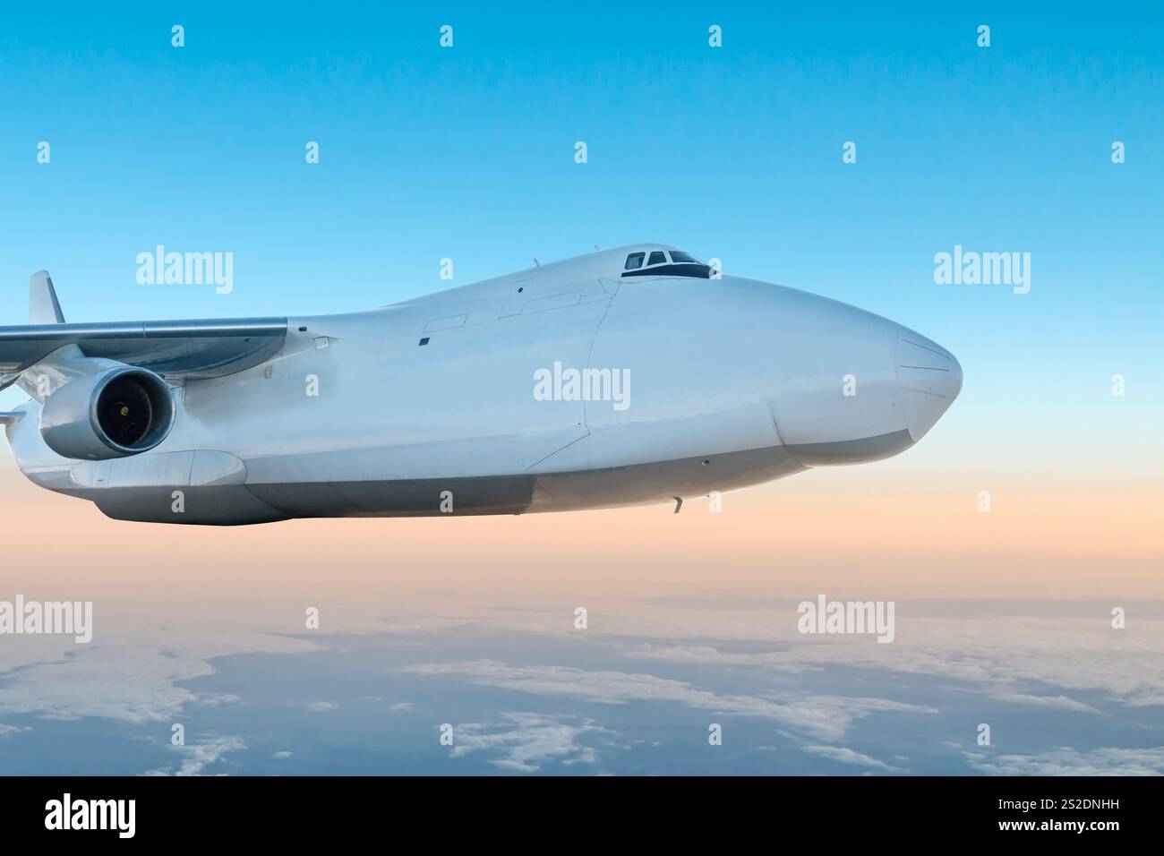 White wide body transport cargo airplane flies in the air Stock Photo ...
