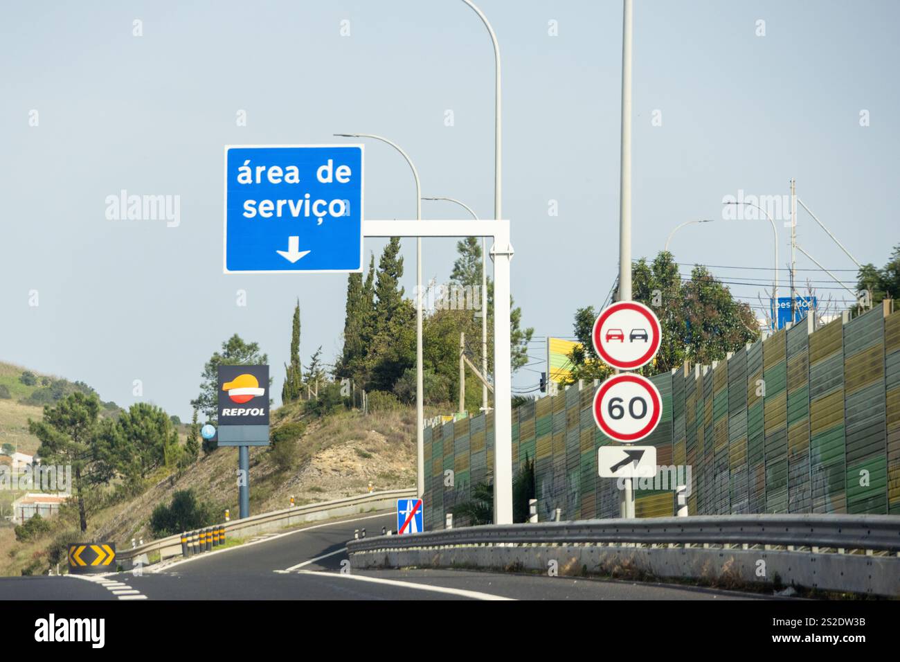Rest area sign indicating services on highway with speed limit and no ...
