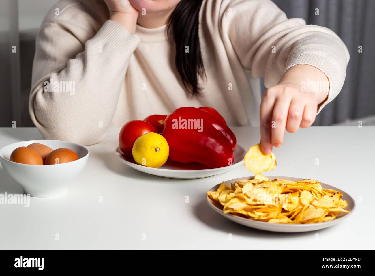 Tired of healthy food woman trying to taste fried chips. Boring dieting ...