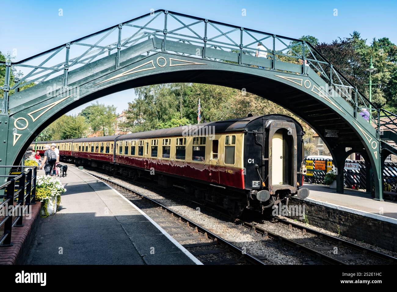 Vintage carriages of diesel electric locomotive passing under ...