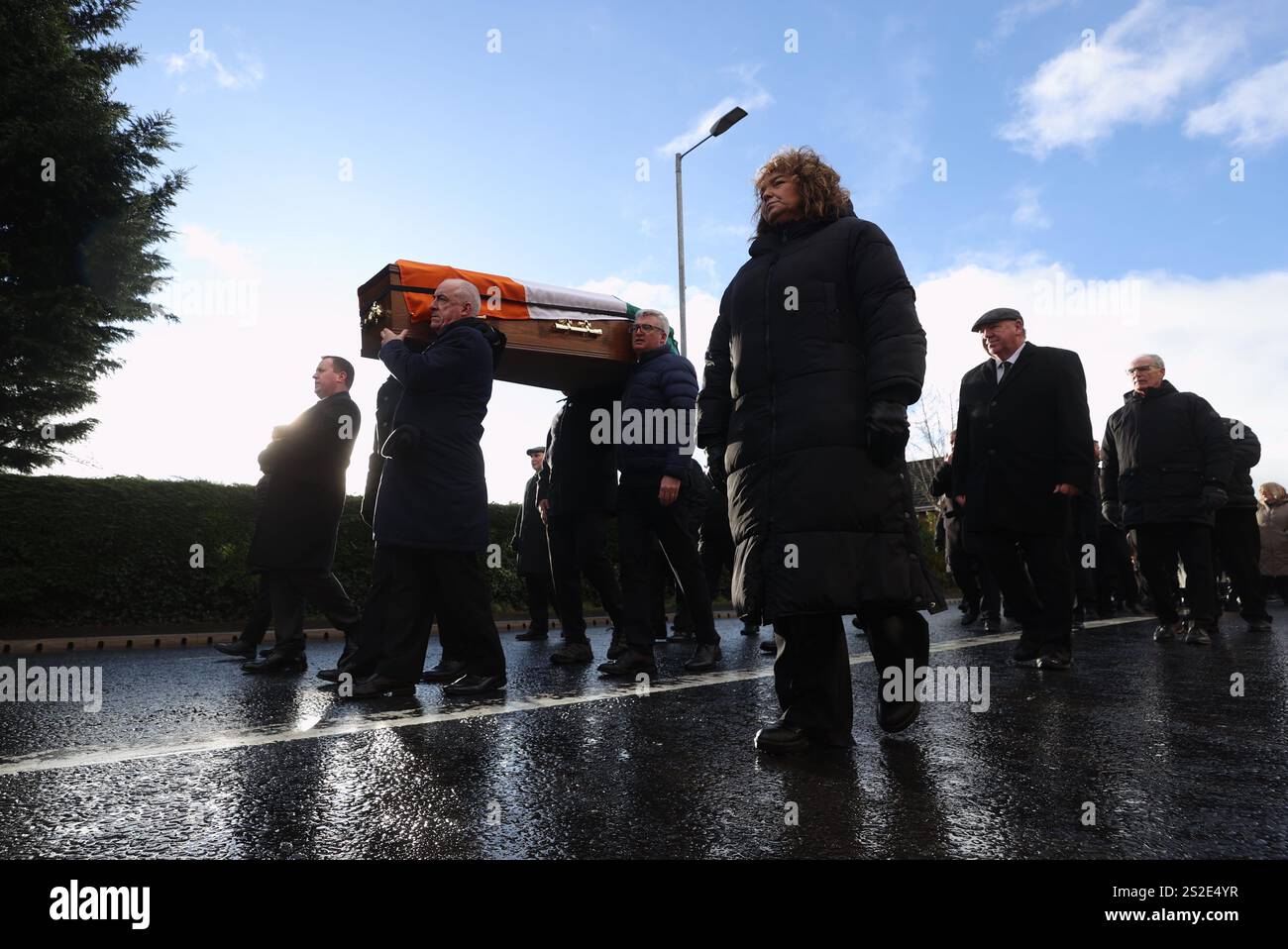 Pall bearers carry the coffin of Ted Howell as it passes though west ...