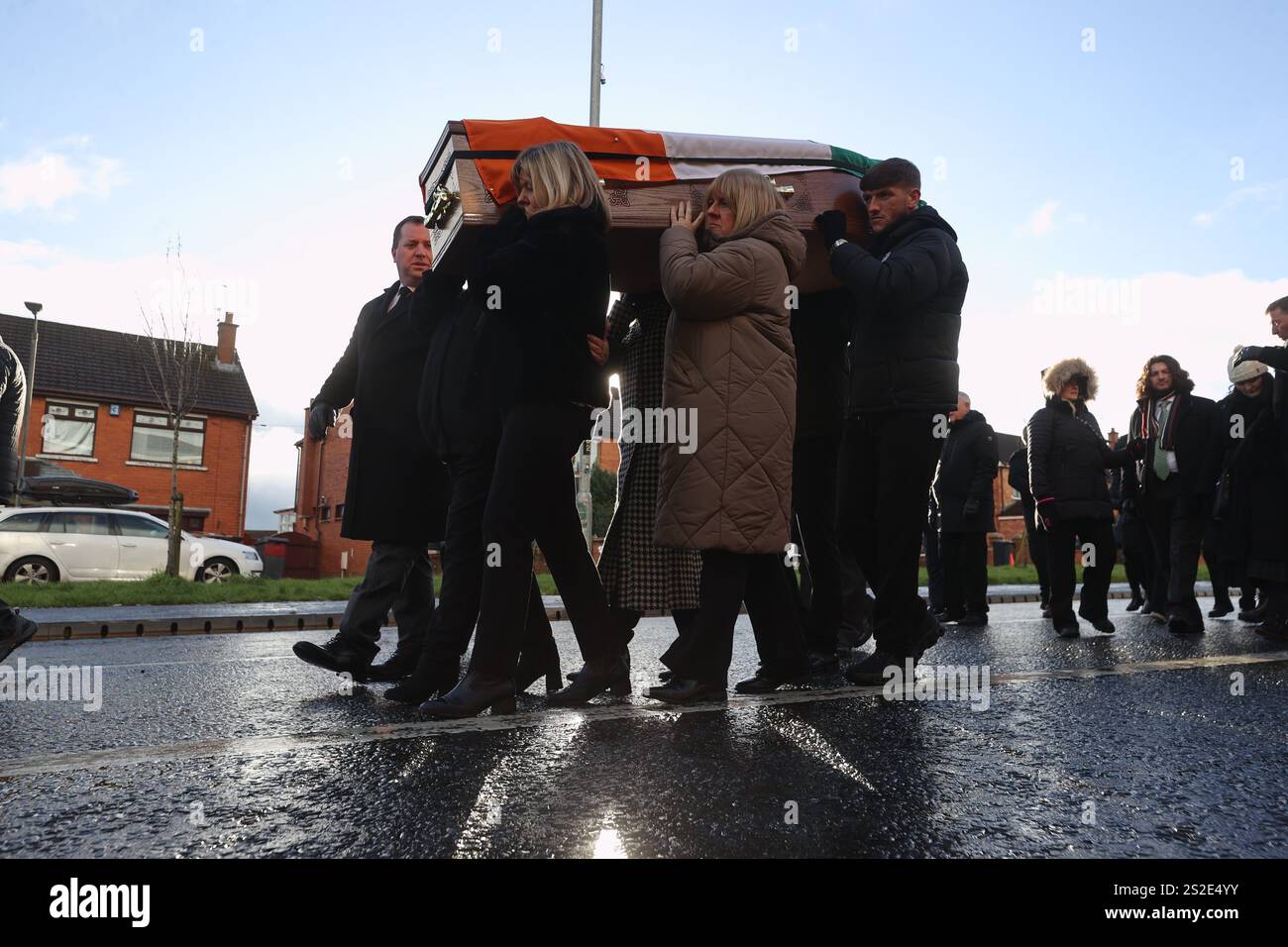 Pall bearers carry the coffin of Ted Howell as it passes though west ...