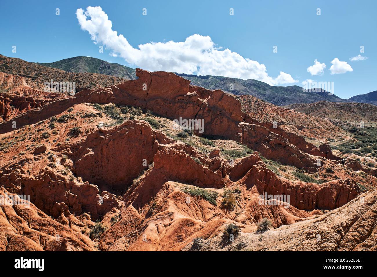 Striking landscape features expansive hills with vibrant hues of red ...