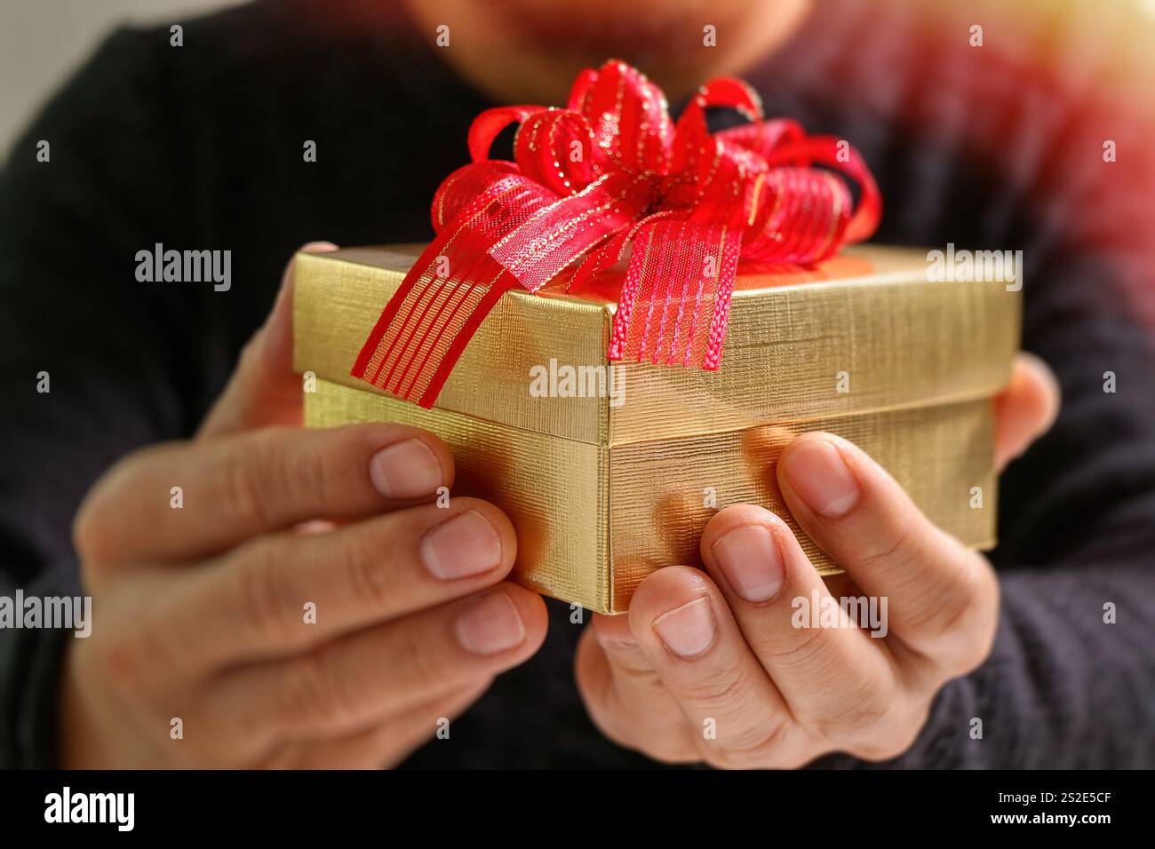gift giving,man hand holding a gift box in a gesture of giving.blurred ...
