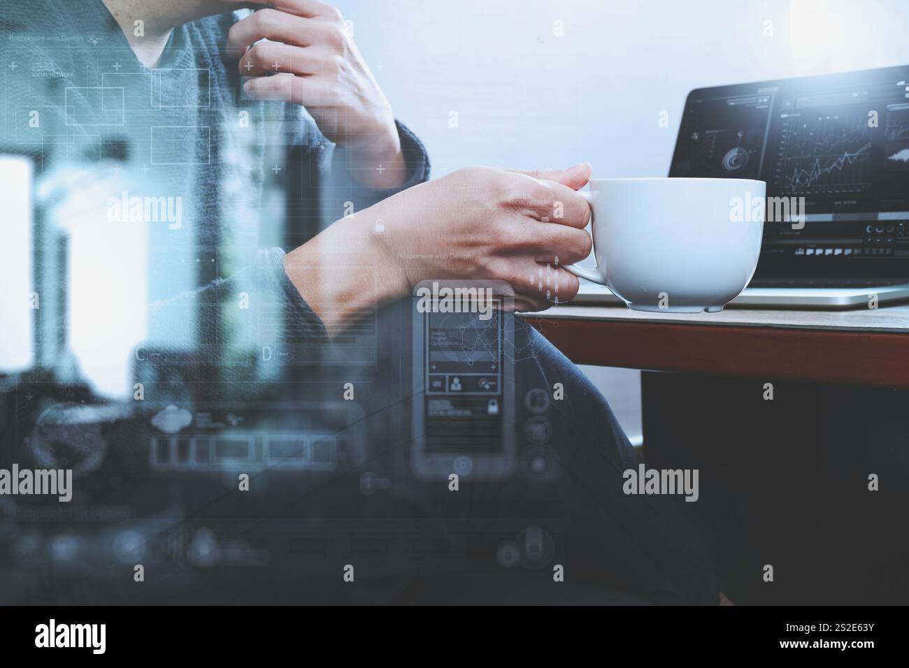 success businessman hand using smart phone,digital tablet docking smart keyboard,coffee cup on ...