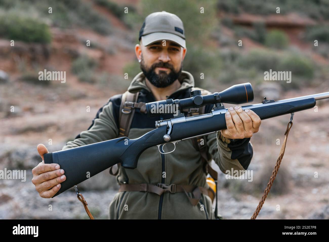 Hunter showing modern hunting rifle with scope in nature Stock Photo ...