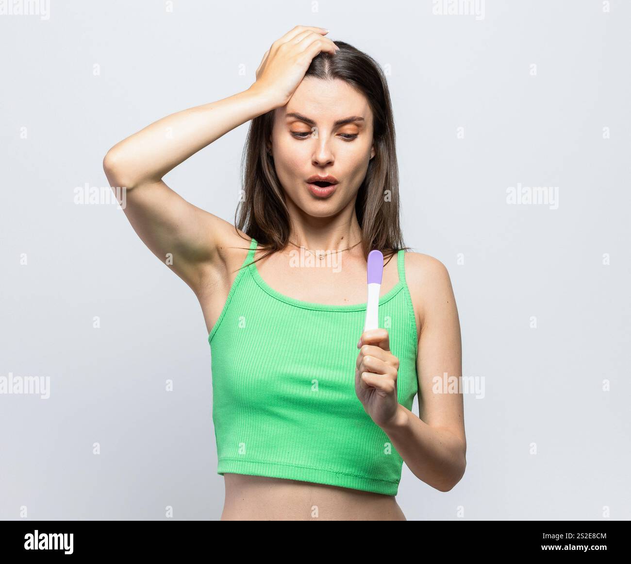 Young woman discovers the result of her pregnancy test and seems ...