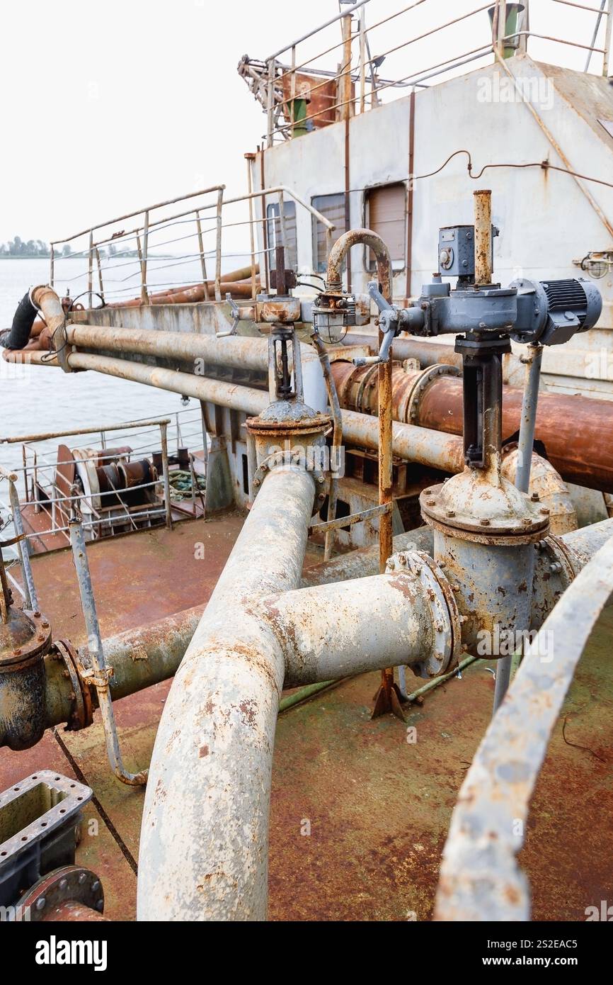 Equipment parts with pipes and windshields of an old rusty repair ship ...