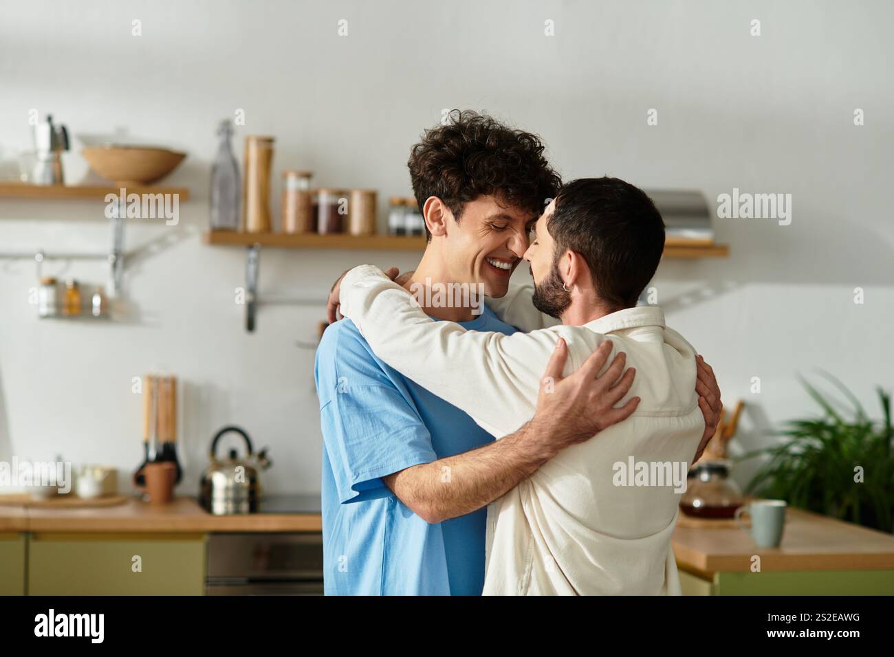 Two men embrace joyfully, sharing love and laughter in their stylish ...