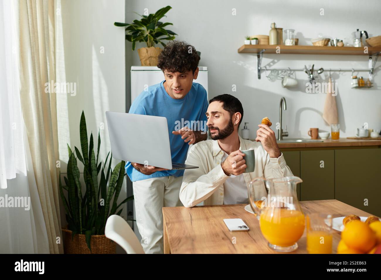 Two men enjoy a cozy breakfast together, sharing laughter and moments ...
