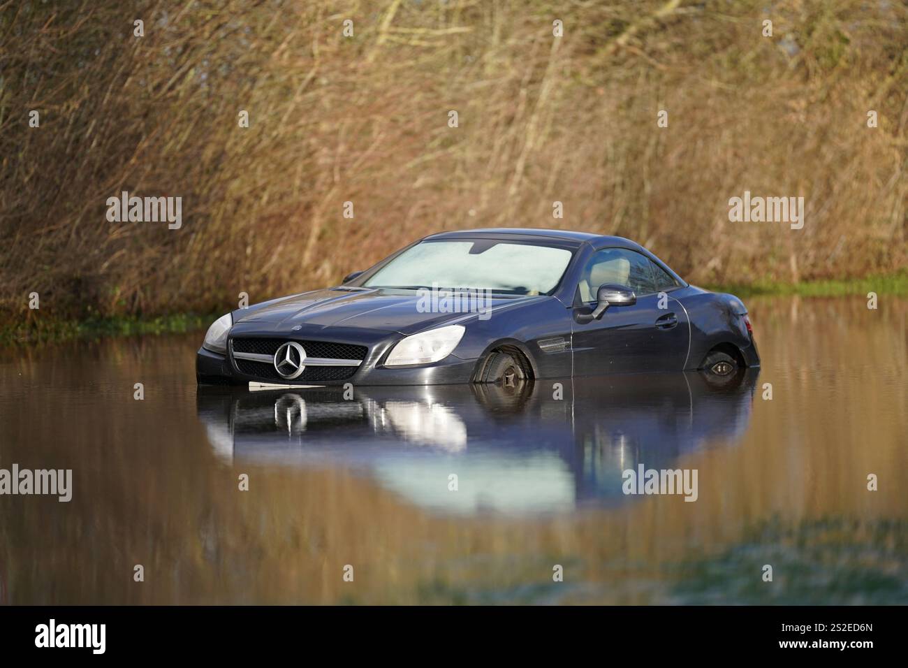 A stranded car in floodwater in Quorn, Leicestershire. Weather warnings ...