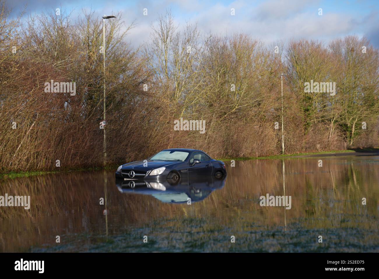 A stranded car in floodwater in Quorn, Leicestershire. Weather warnings ...