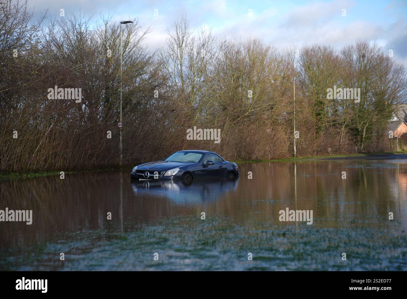 A stranded car in floodwater in Quorn, Leicestershire. Weather warnings ...