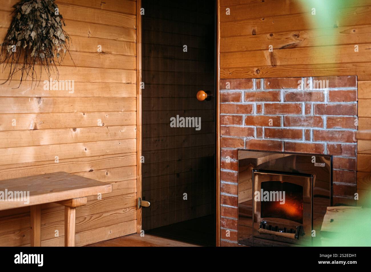 Cozy home sauna with wooden interior, brick fireplace, and dried sauna ...