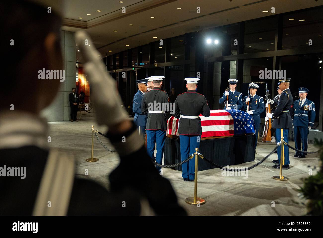 Members of the joint services military honor guard salute during the changing of the guard as ...