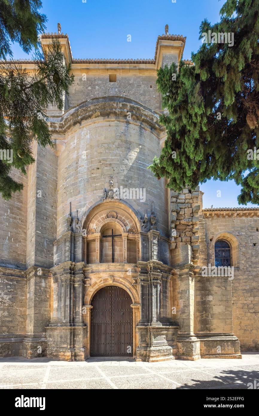 Ronda town in Spain. Ancient stone church entrance under a clear blue ...