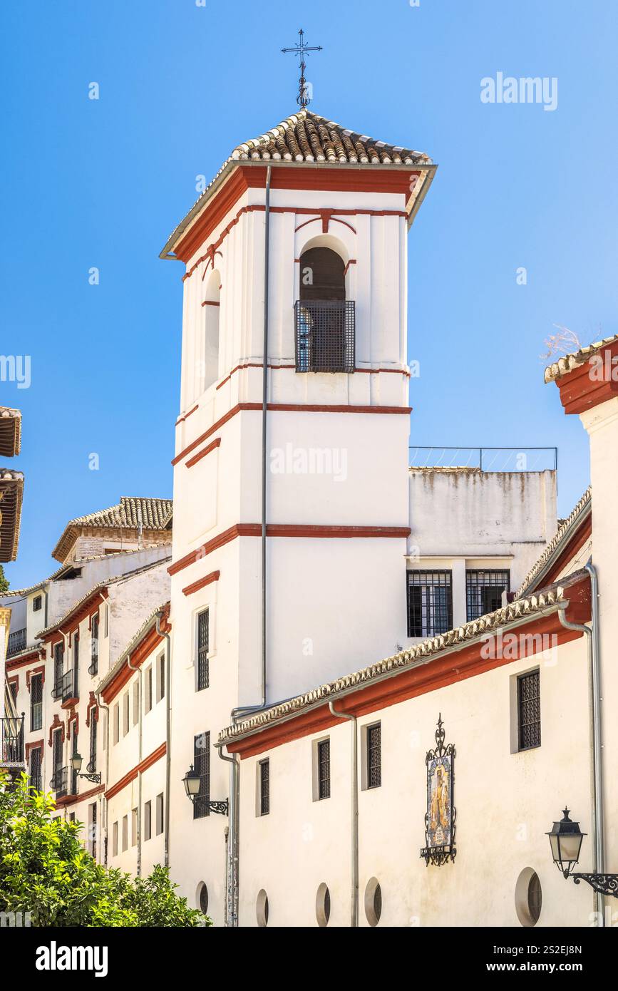 Granada town in Spain. White building with red trim and a bell tower ...