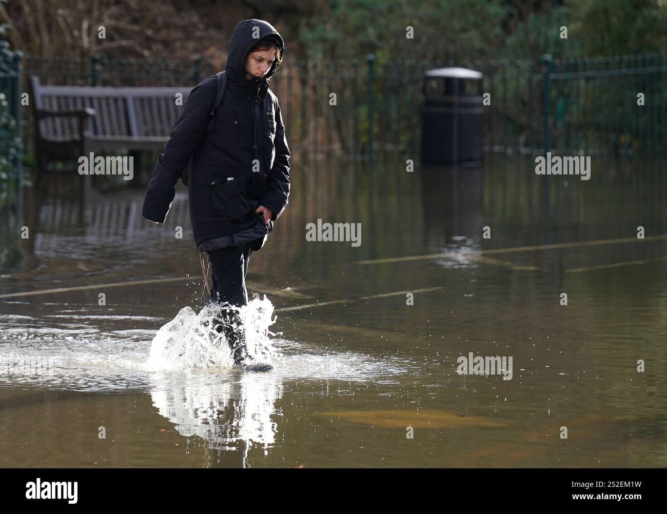 A person walks through floodwater in Quorn, Leicestershire. Weather ...