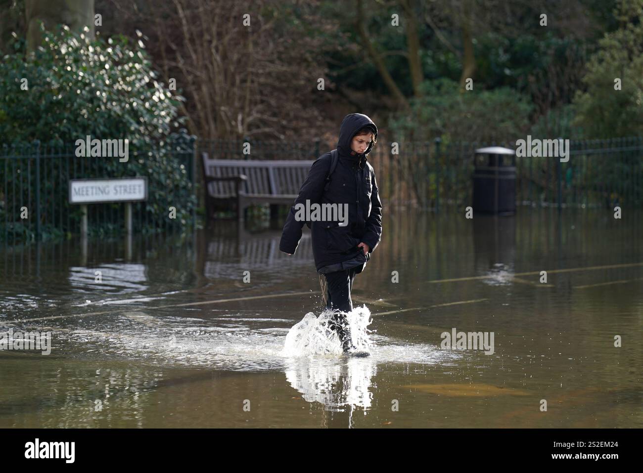 A person walks through floodwater in Quorn, Leicestershire. Weather ...