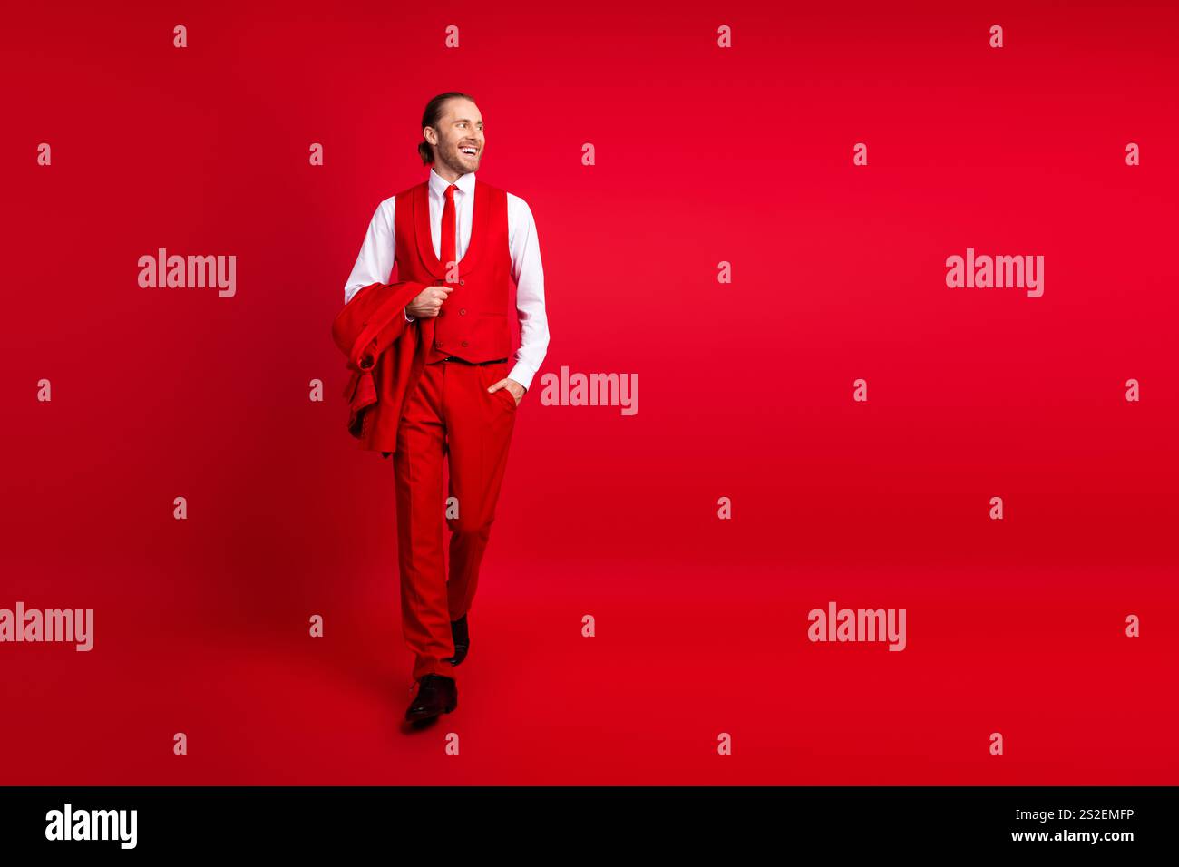 Full size photo of handsome young guy hold jacket walk look empty space ...