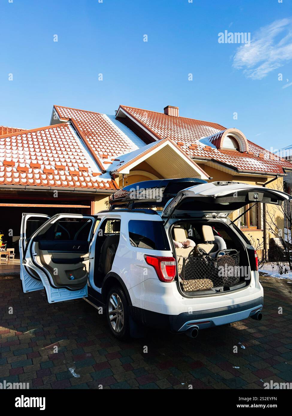 A spacious white SUV packed and ready for a road trip, located outside ...